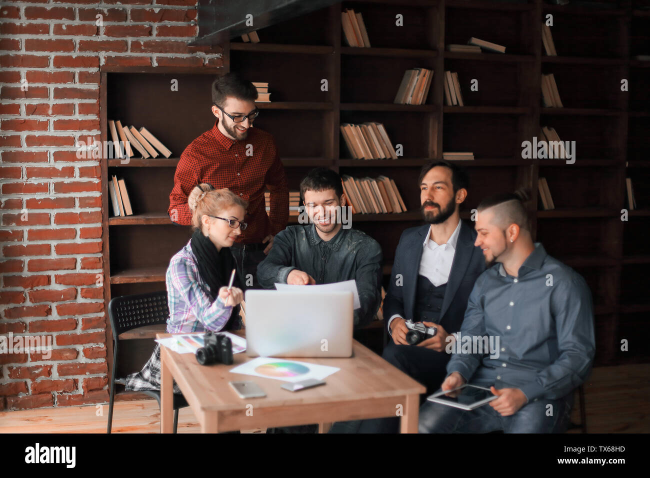 successful group of designers discussing a new advertising project ...