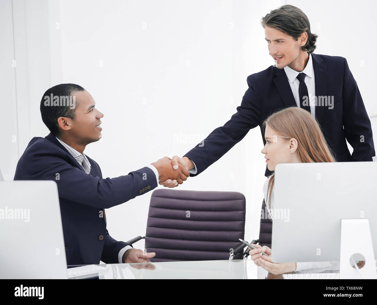 closeup .the handshake between colleagues in the workplace .photo with ...