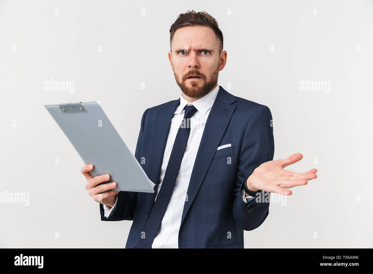 Image of young confused businessman posing isolated over white wall ...