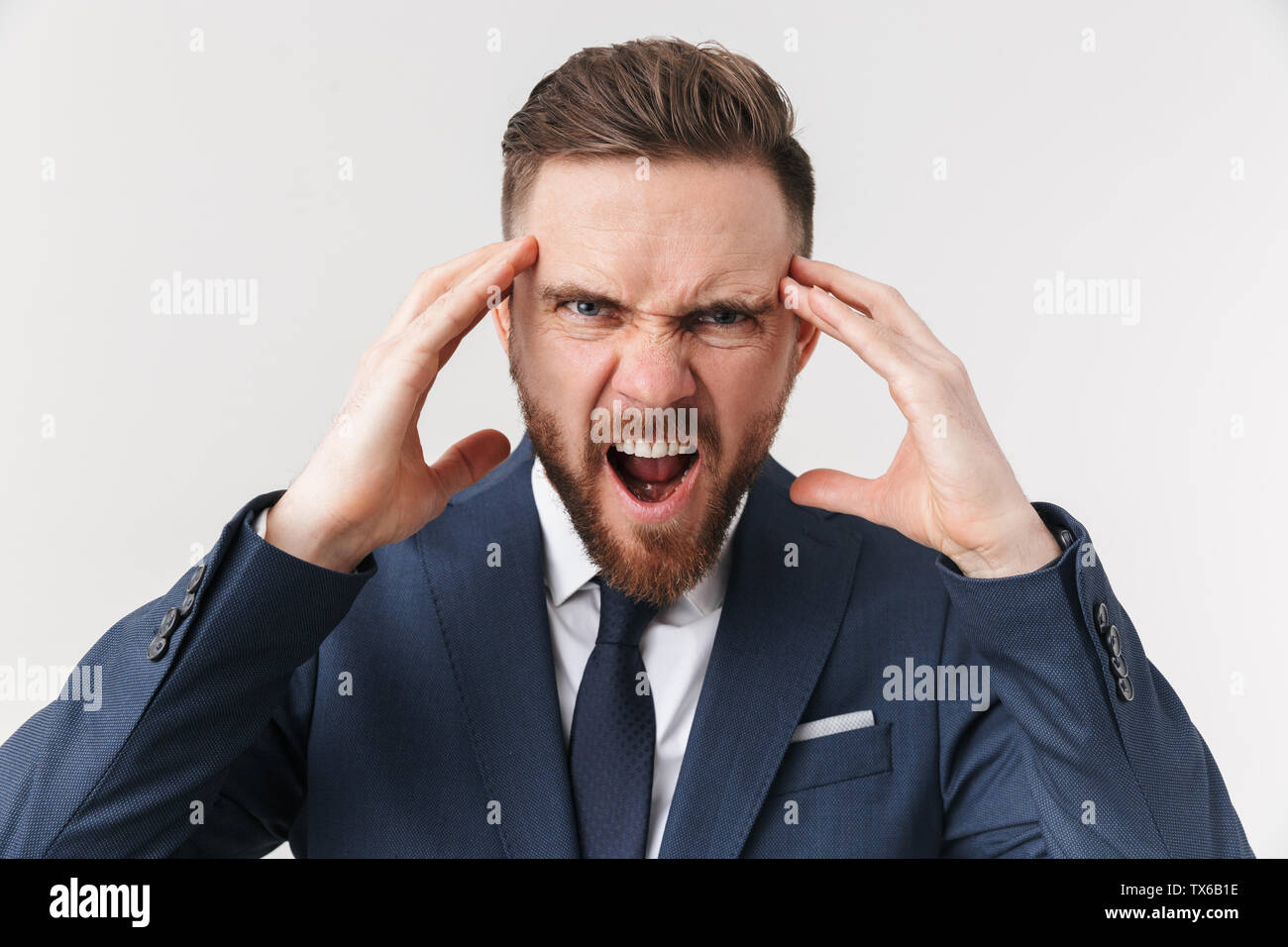 Image of young screaming businessman posing isolated over white wall ...