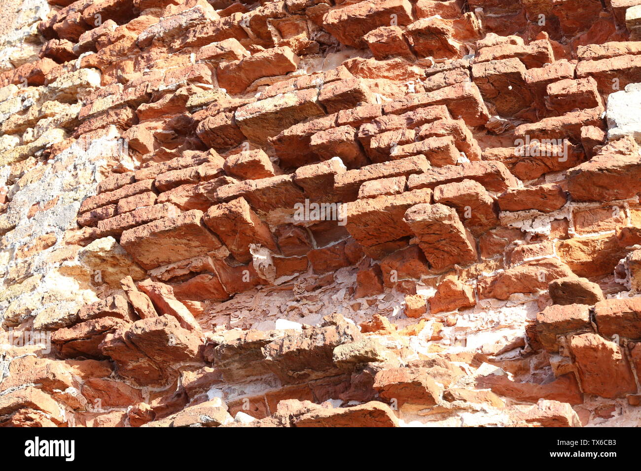 The old red brick fortress wall is crumbling Stock Photo - Alamy