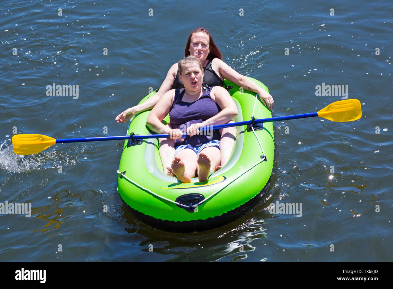 Two women having fun in inflatable dinghy on Dorset Dinghy Day at Iford ...