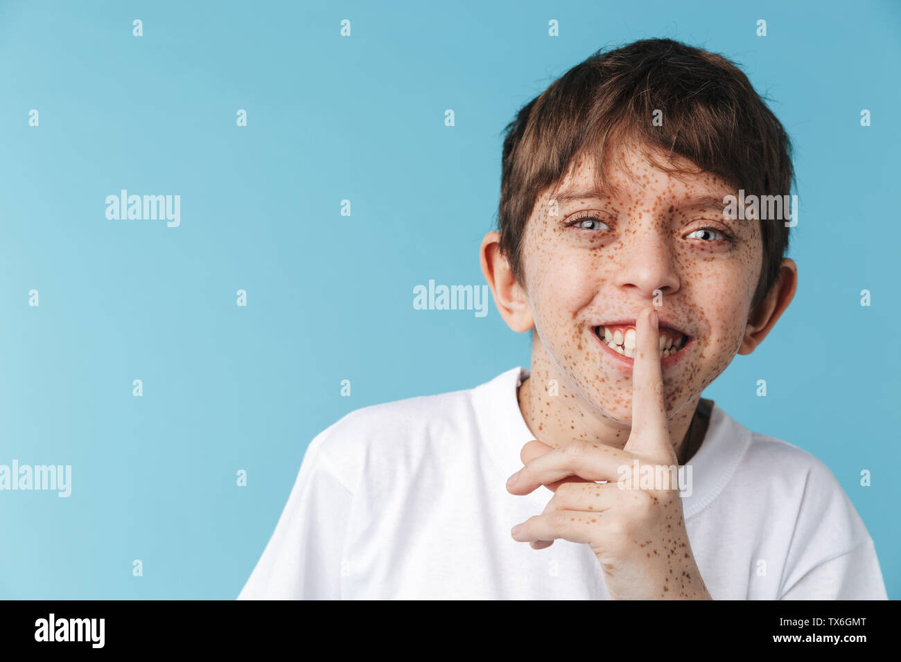 Image of happy boy 10-12y with freckles wearing white casual t-shirt ...