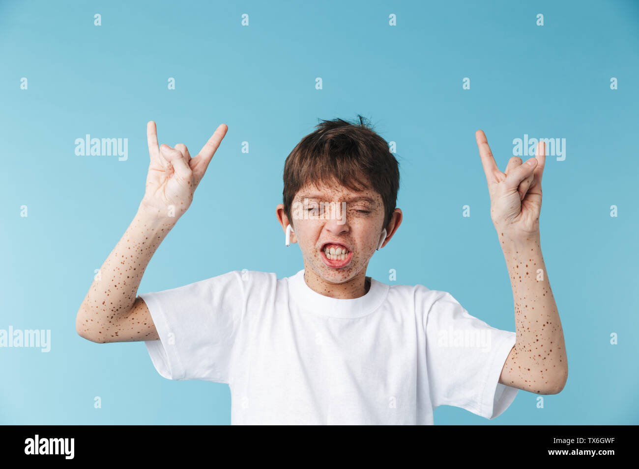 Image of ecstatic caucasian boy 10-12y with freckles wearing white ...