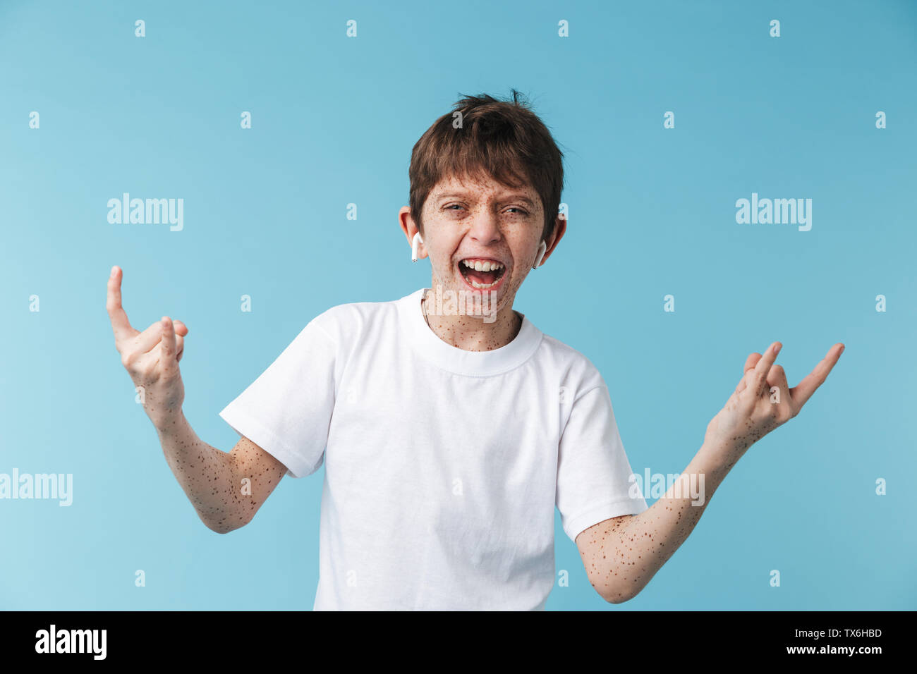 Image of ecstatic caucasian boy 10-12y with freckles wearing white ...