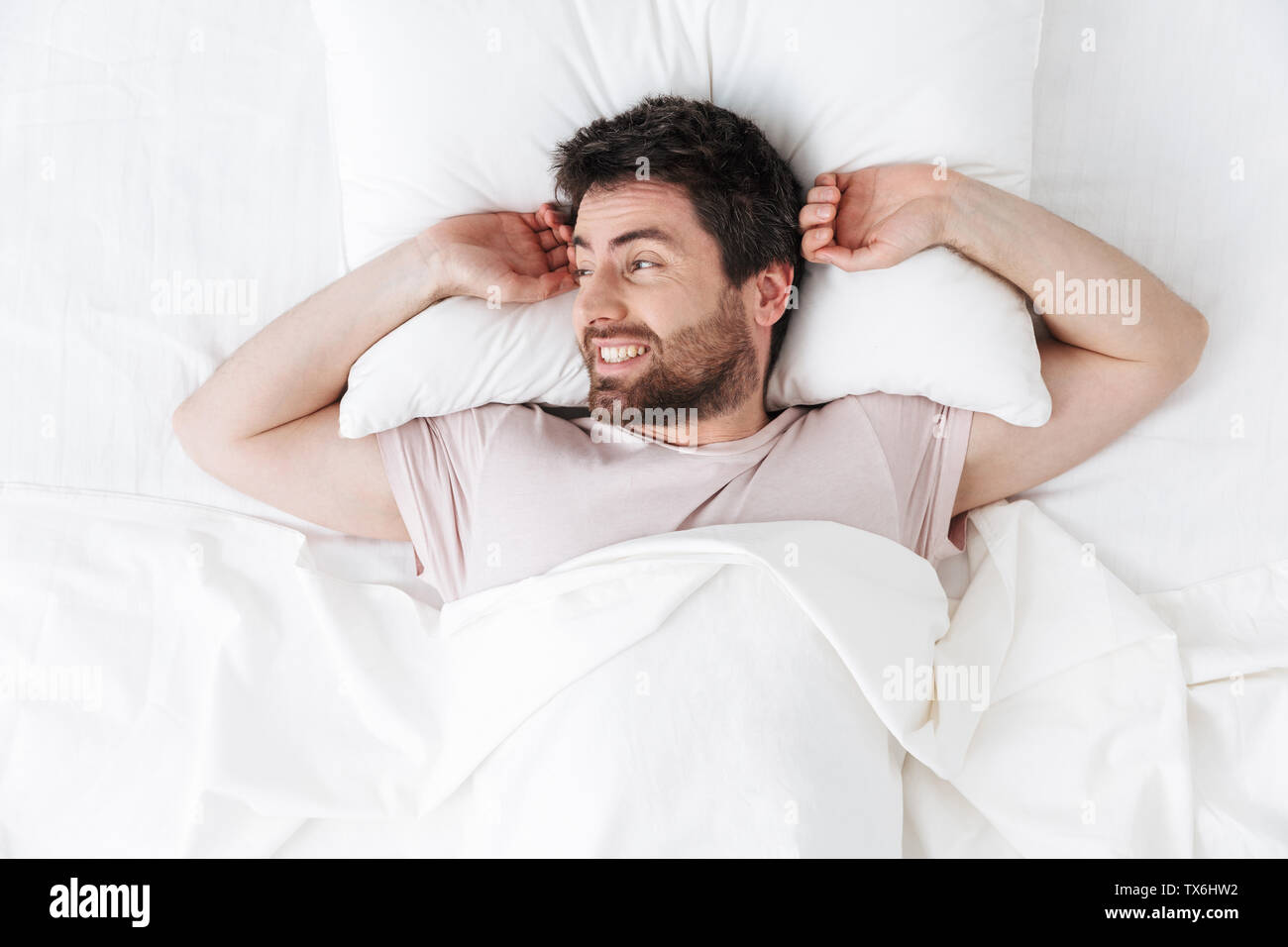 Image of a handsome young man in the morning stretching in bed Stock ...