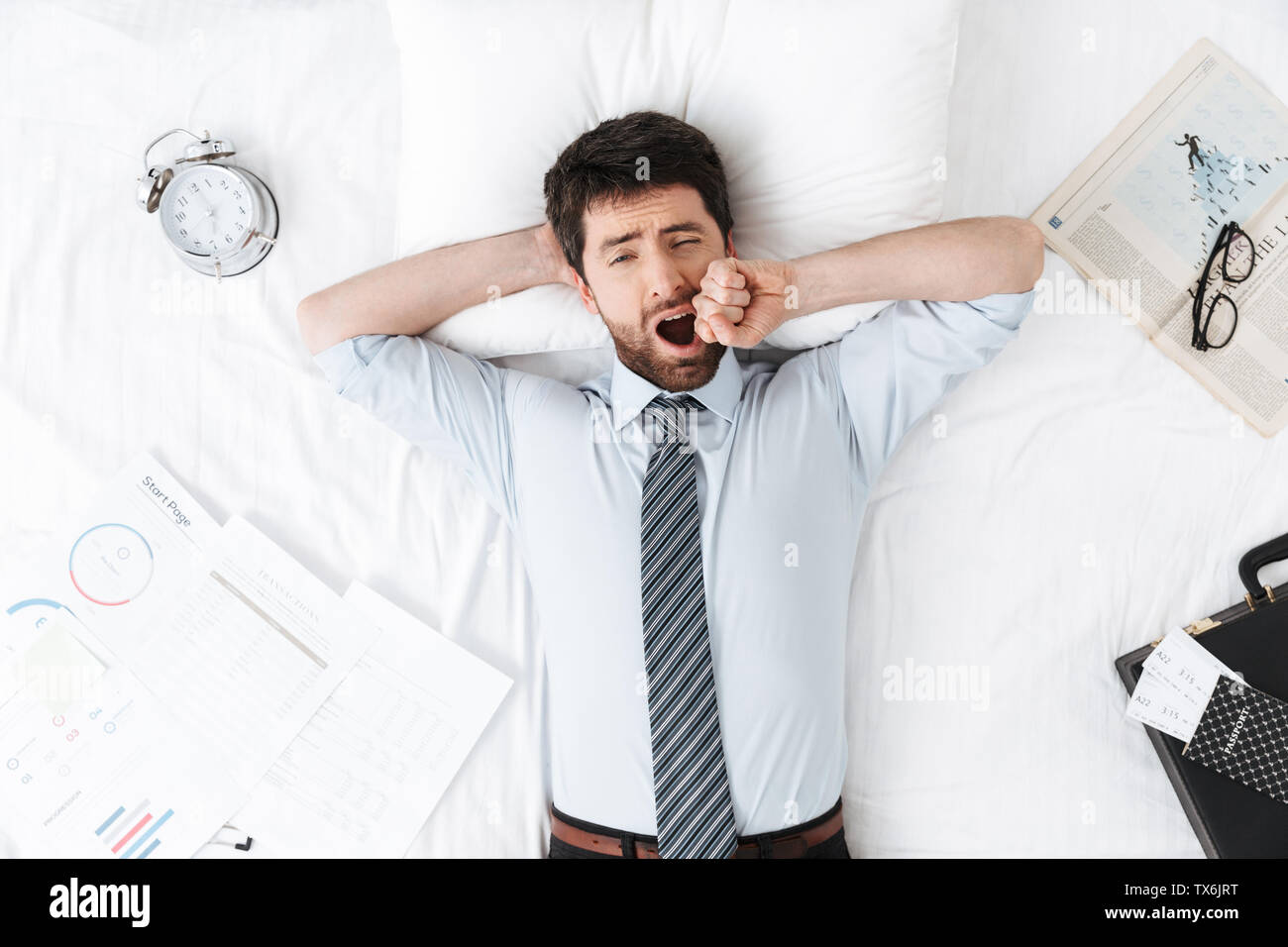 Young man yawning in bed hi-res stock photography and images - Alamy