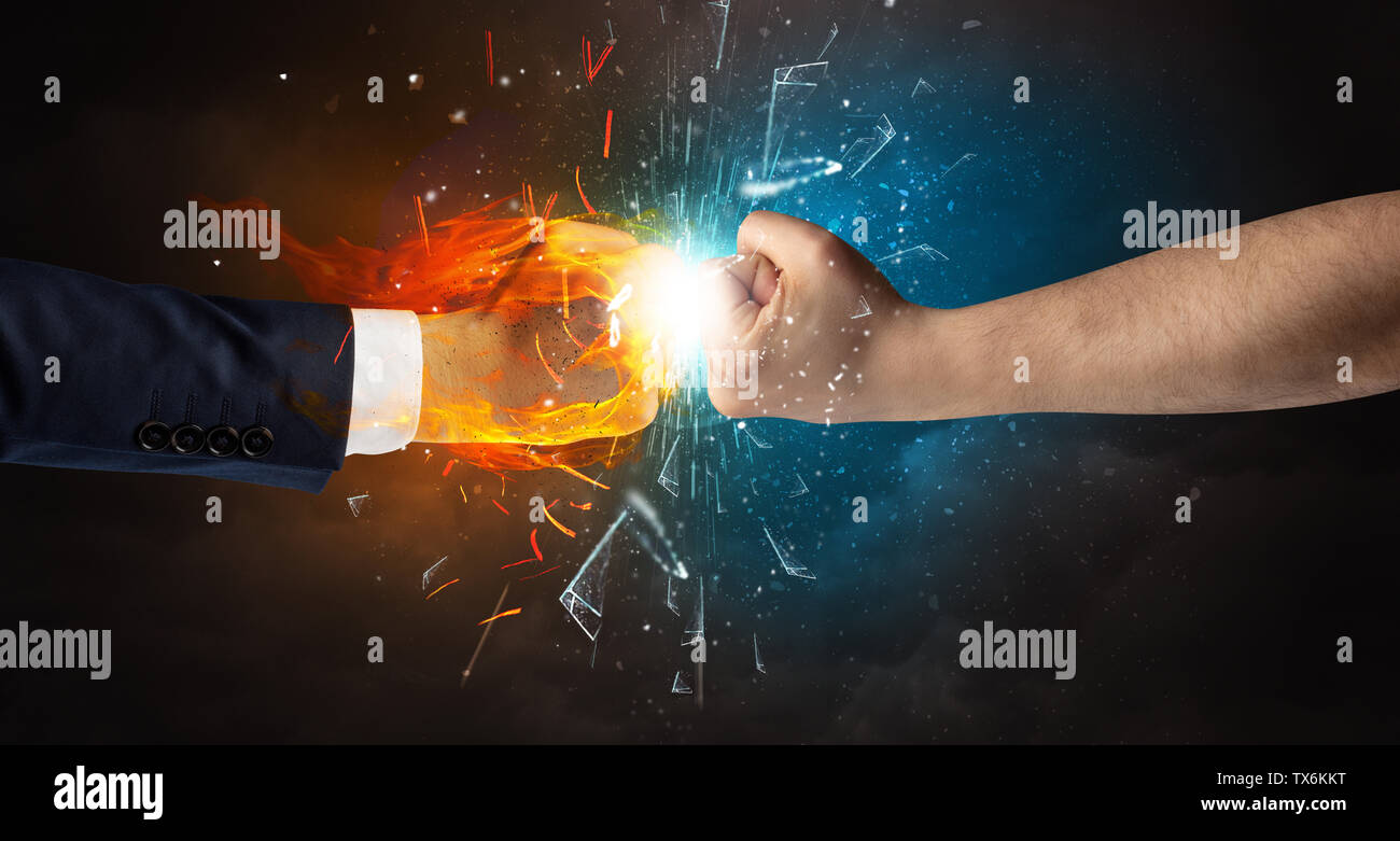 Two hands fighting and breaking glass into small pieces with fire and ...