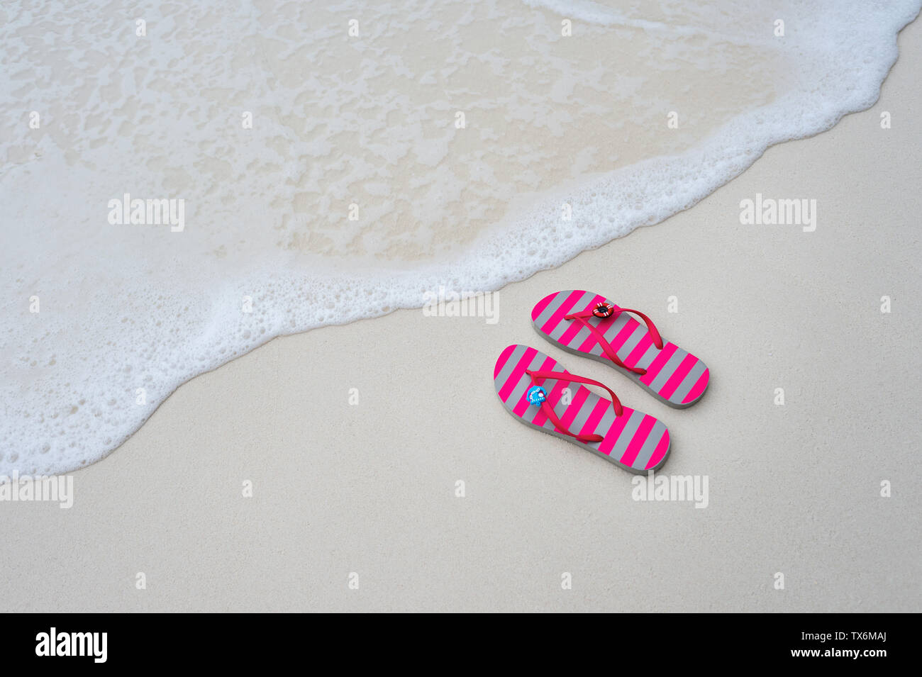 Flip flops on the beach Stock Photo - Alamy