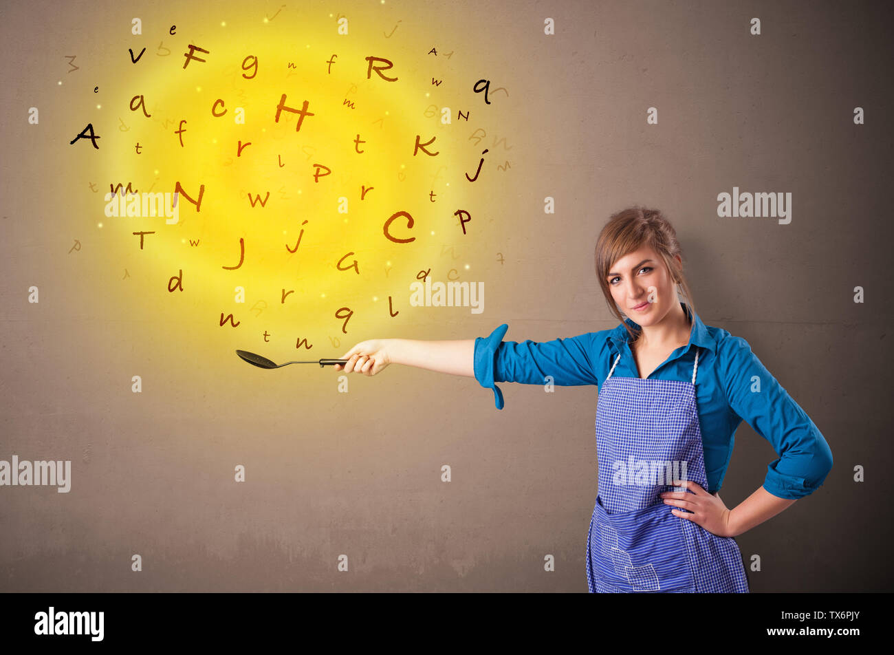 Young person cooking letters in wok Stock Photo - Alamy