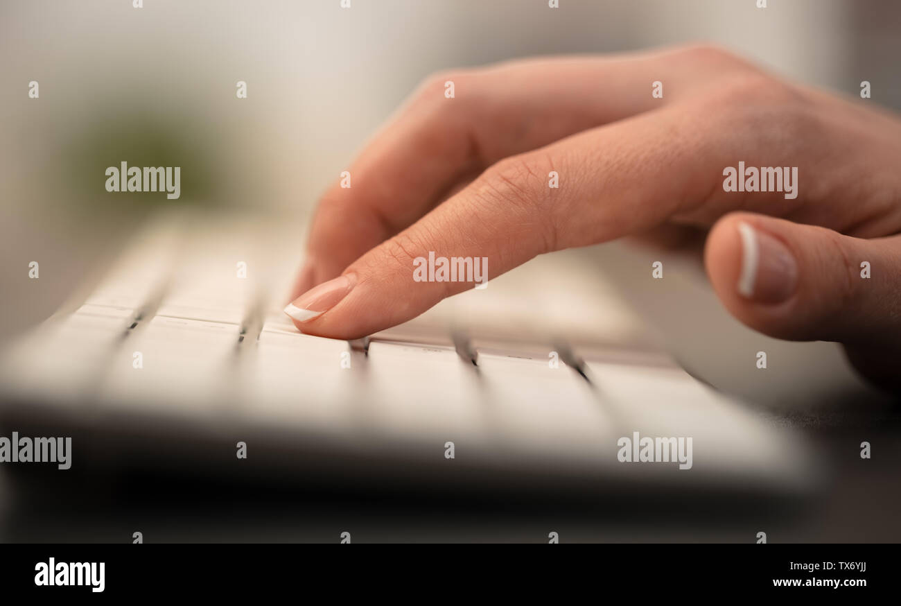 Hand typing on keyboard with office concept Stock Photo - Alamy