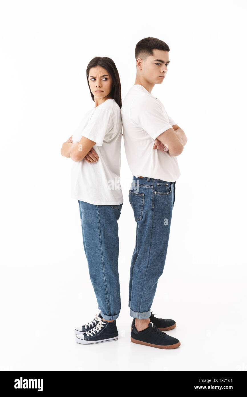 Full length portrait of an attractive upset young couple standing back ...