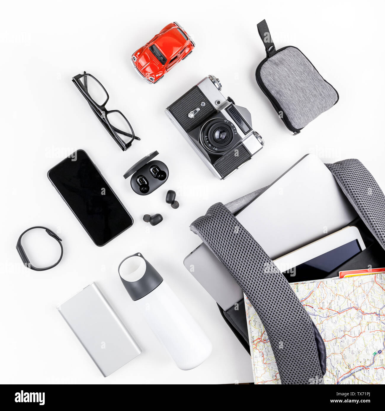 Creative top view flat lay of open backpack with laptop and tablet ...