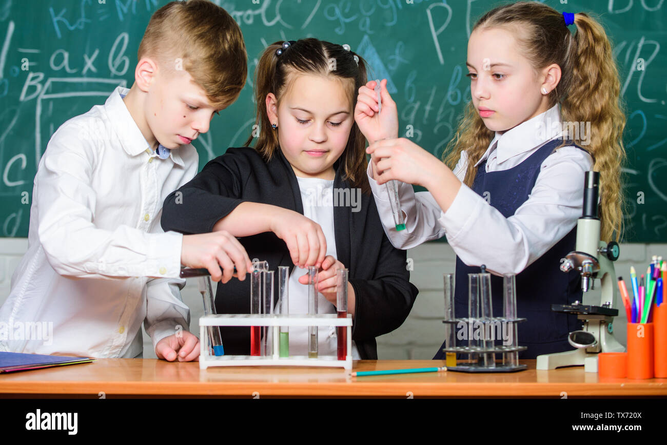 Little kids learning chemistry in school lab. students doing biology ...