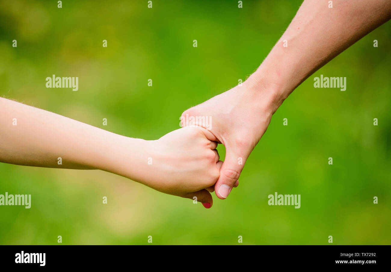 help and support. father hold his child with hand. hands together ...