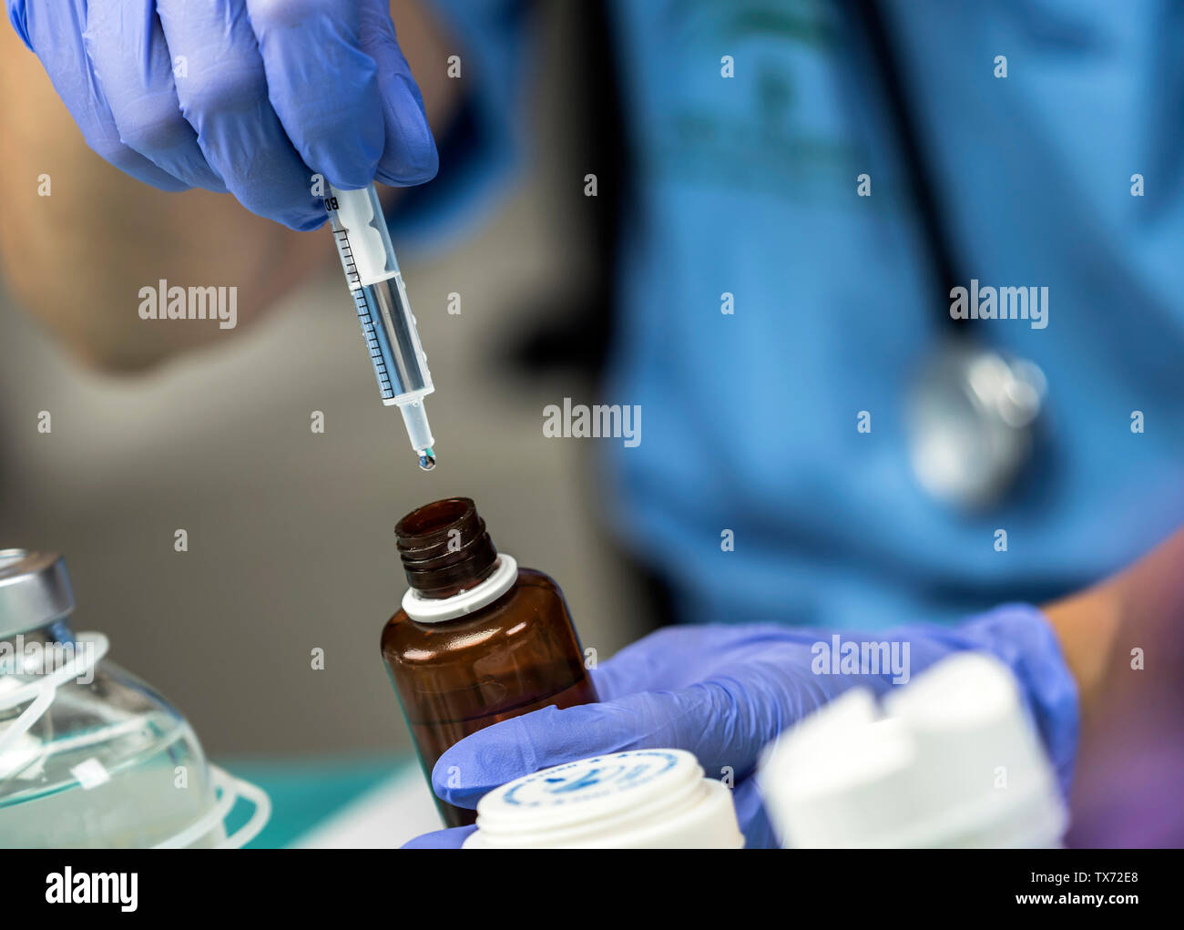 Nurse supplies dropper medication in a hospital, conceptual image Stock ...