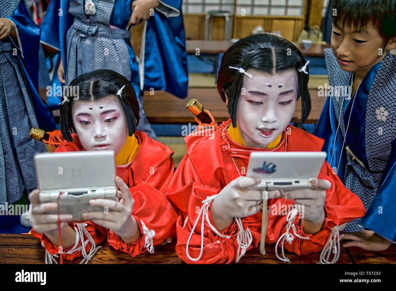 Young boys playing electronic games before while waiting to celebrate ...