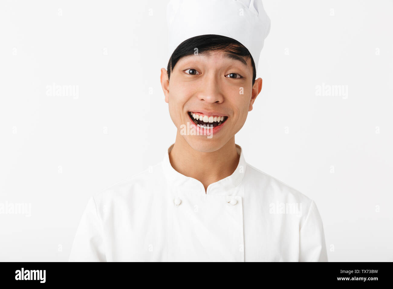 Image of asian happy chief man in white cook uniform smiling at camera ...