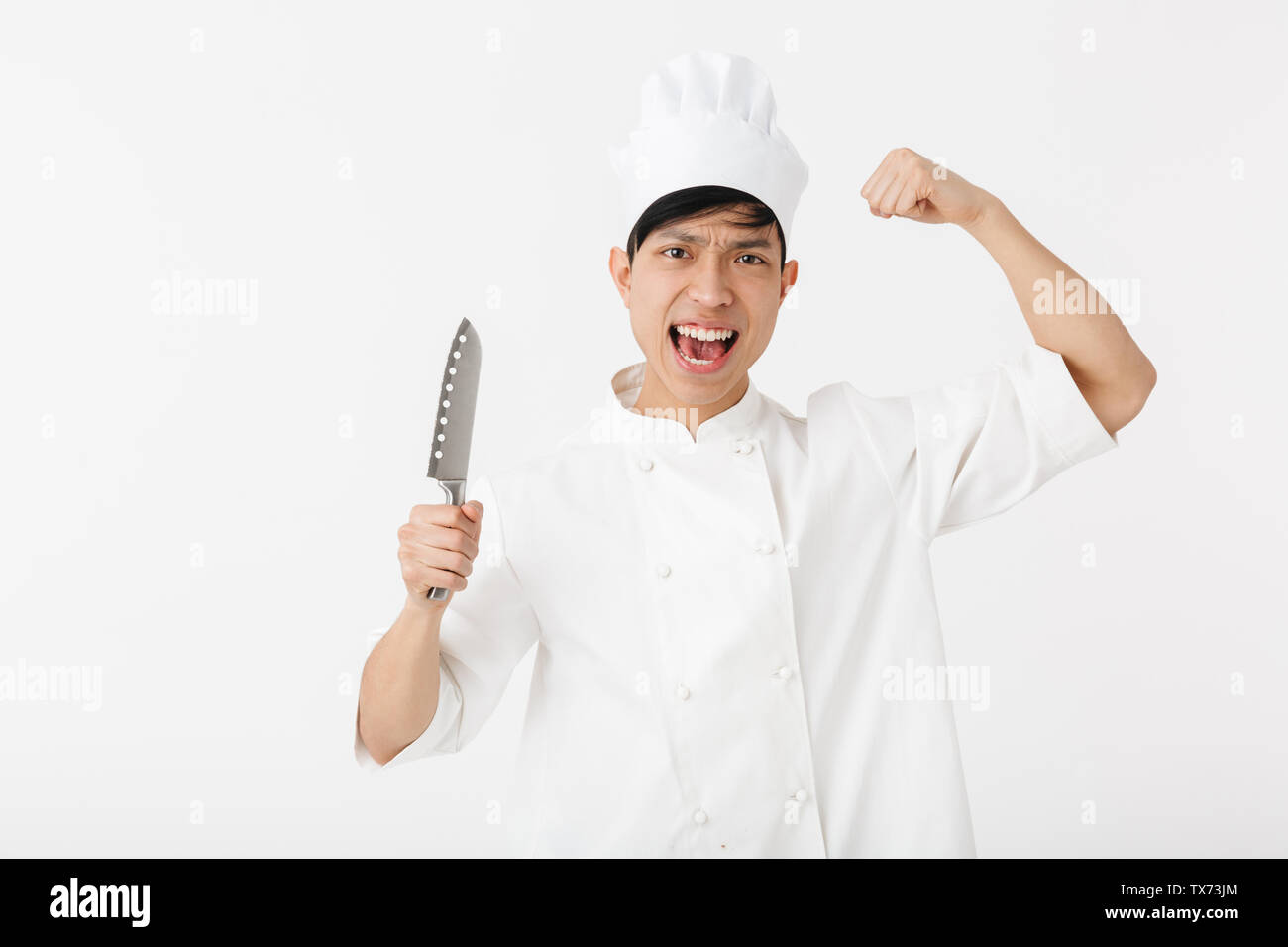 Image of asian excited chief man in white cook uniform smiling at ...