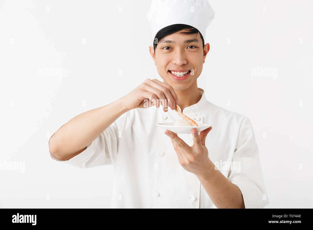 Image of handsome chinese chief man in white cook uniform smiling at ...