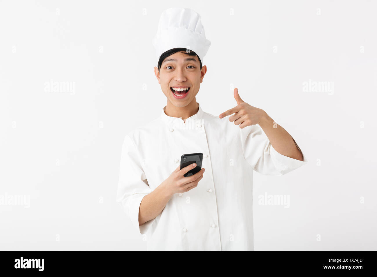 Image of young chinese chief man in white cook uniform and chef's hat ...