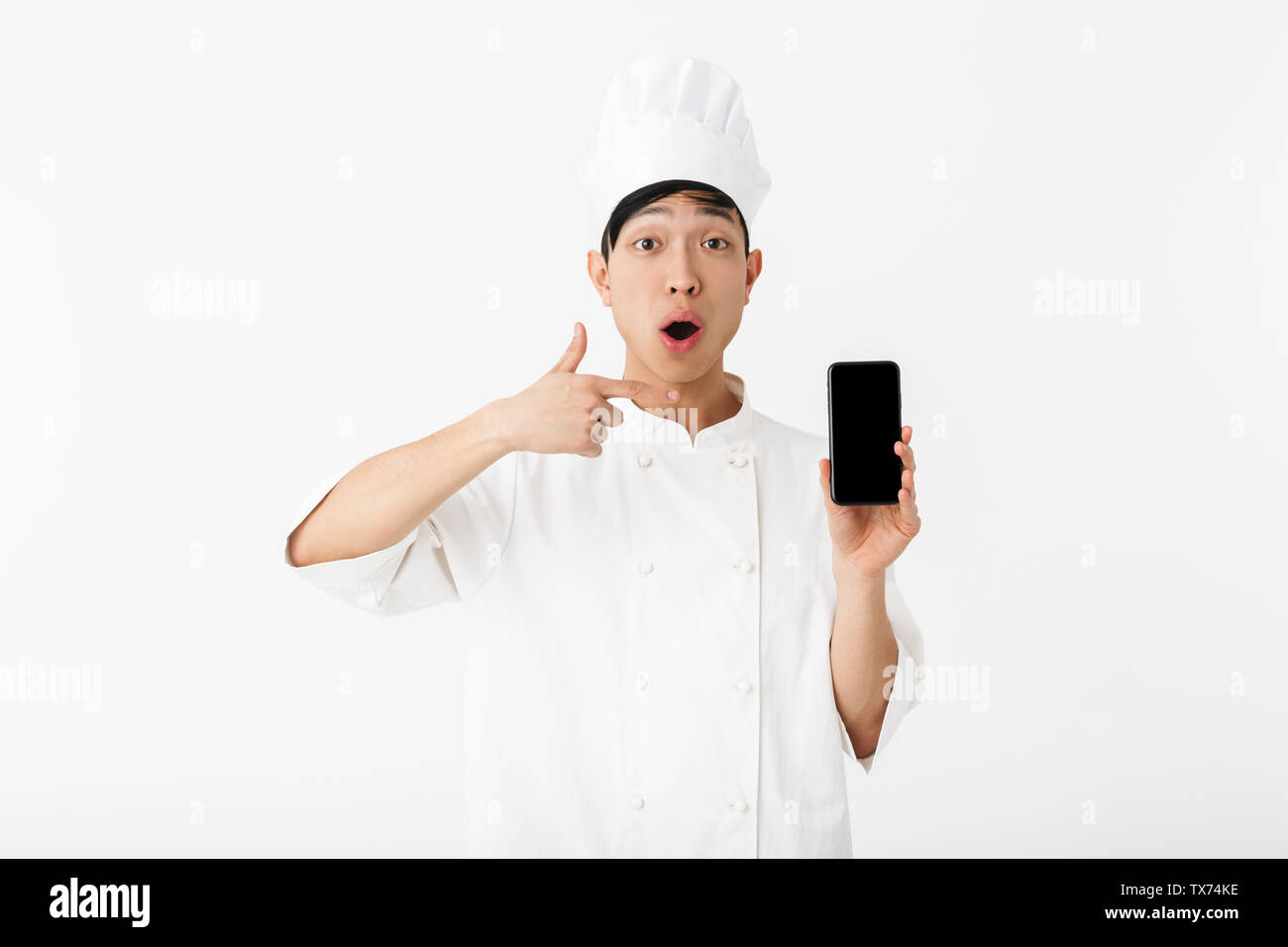 Image of excited chinese chief man in white cook uniform and chef's hat ...