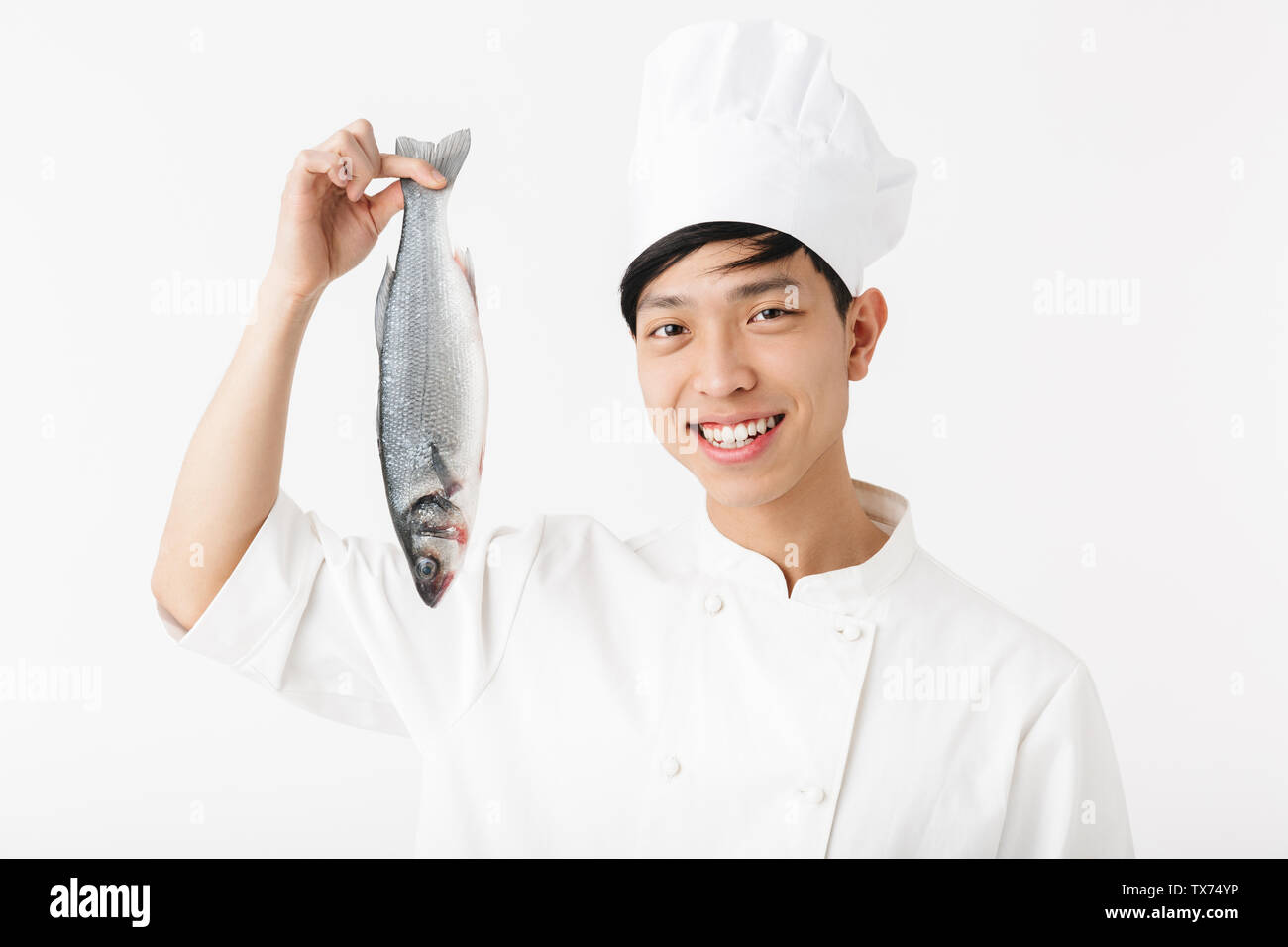 Image of young japanese chief man in white cook uniform and hat smiling ...