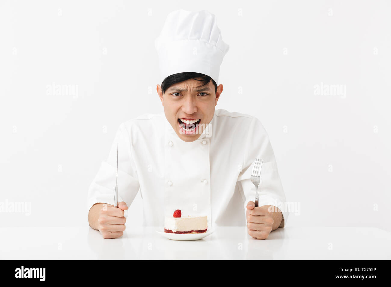 Image of nervous asian chief man in white cook uniform screaming while ...
