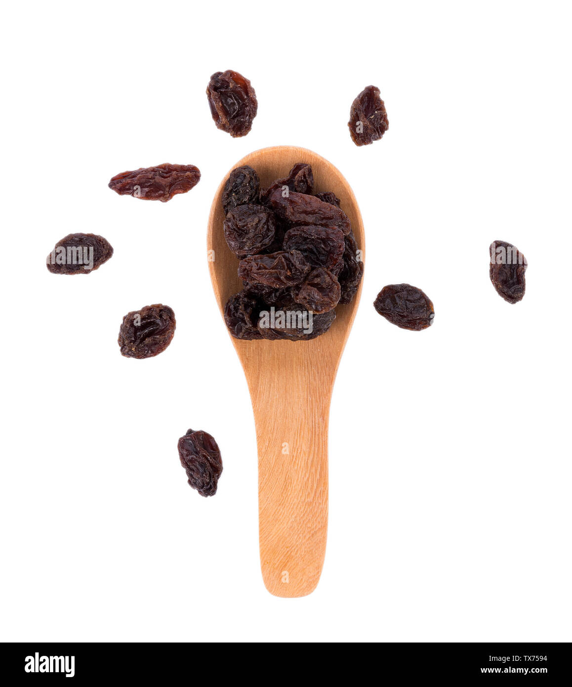 Dried raisins in spoon on white background Stock Photo - Alamy