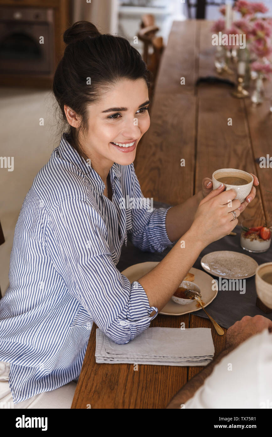 Happy young couple having cup of tea in the morning Stock Photo - Alamy