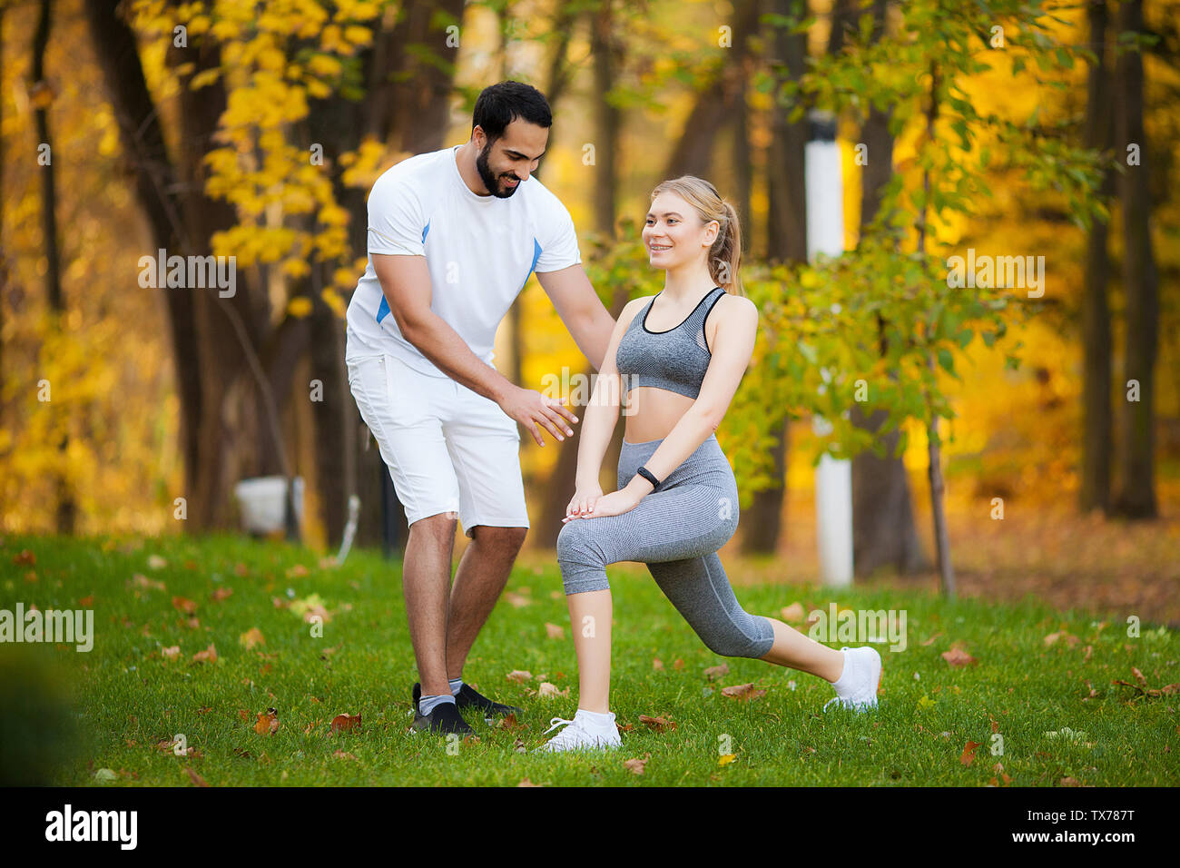 Fitness. Personal Trainer Takes Notes While Woman Exercising Outdoor ...