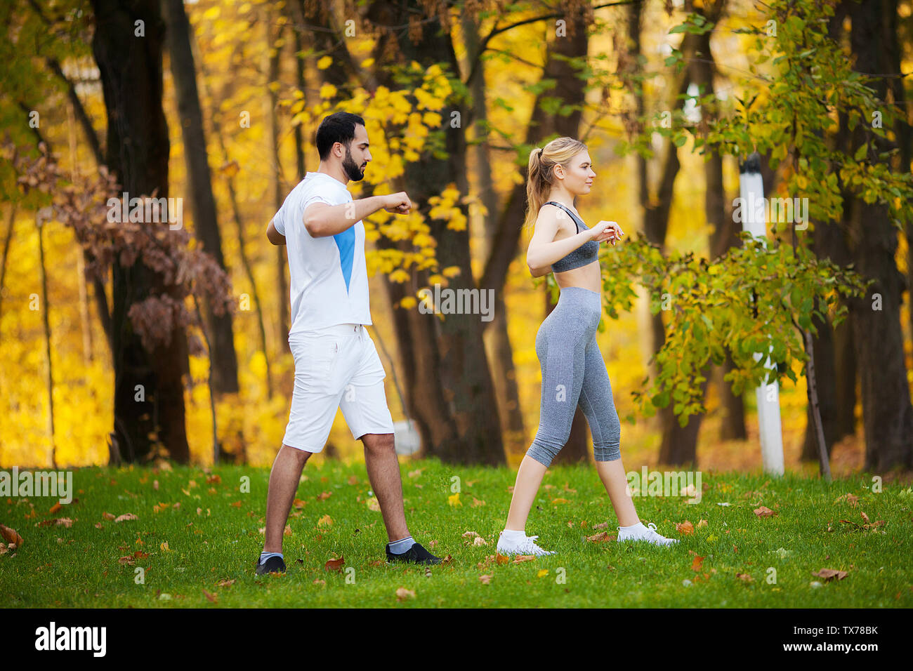 Fitness. Personal Trainer Takes Notes While Woman Exercising Outdoor ...
