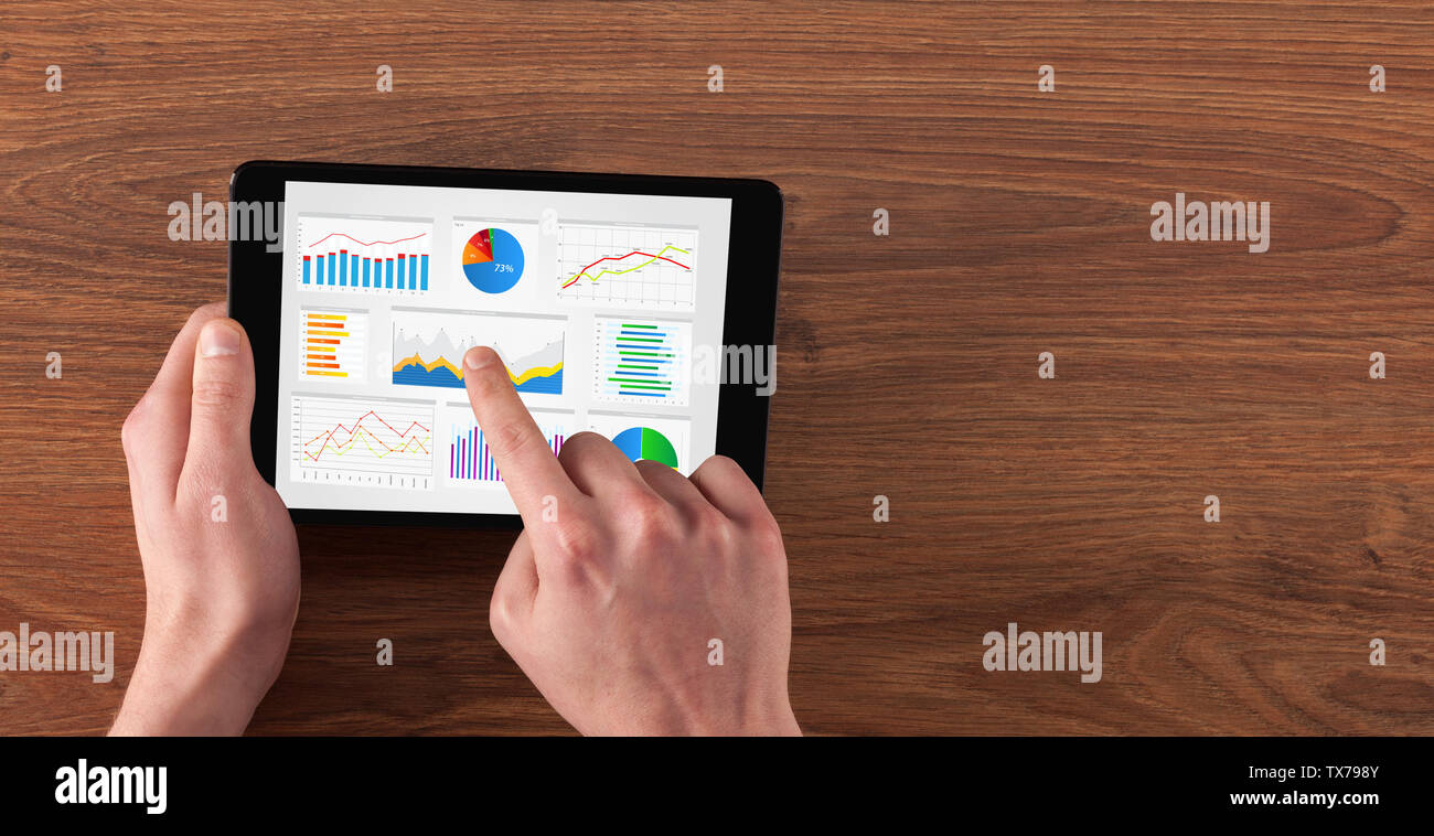 Hand making diagrams and charts on tablet Stock Photo - Alamy