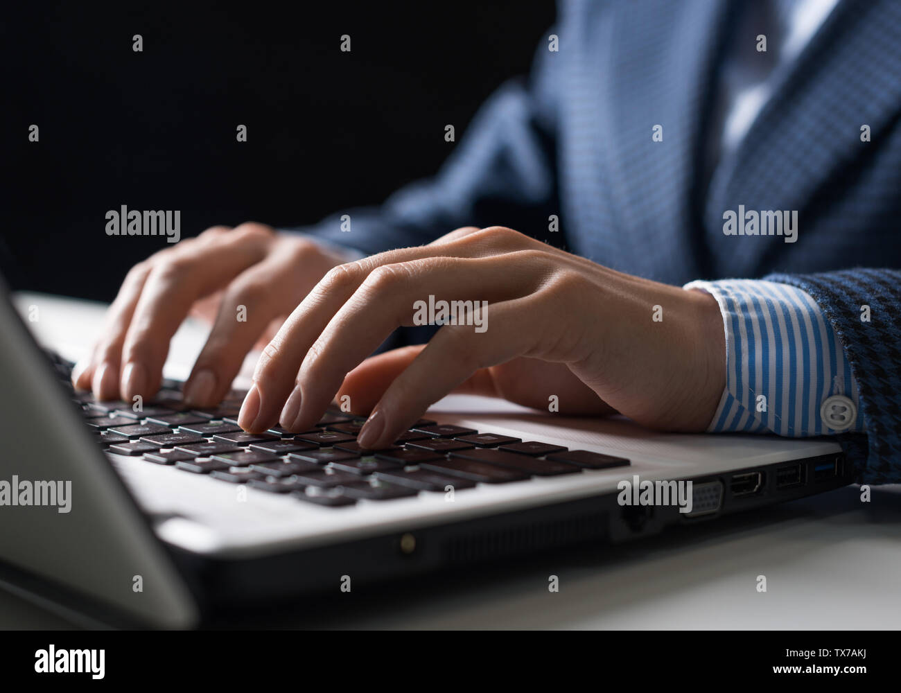Man in business suit sitting at desk and working at laptop computer ...