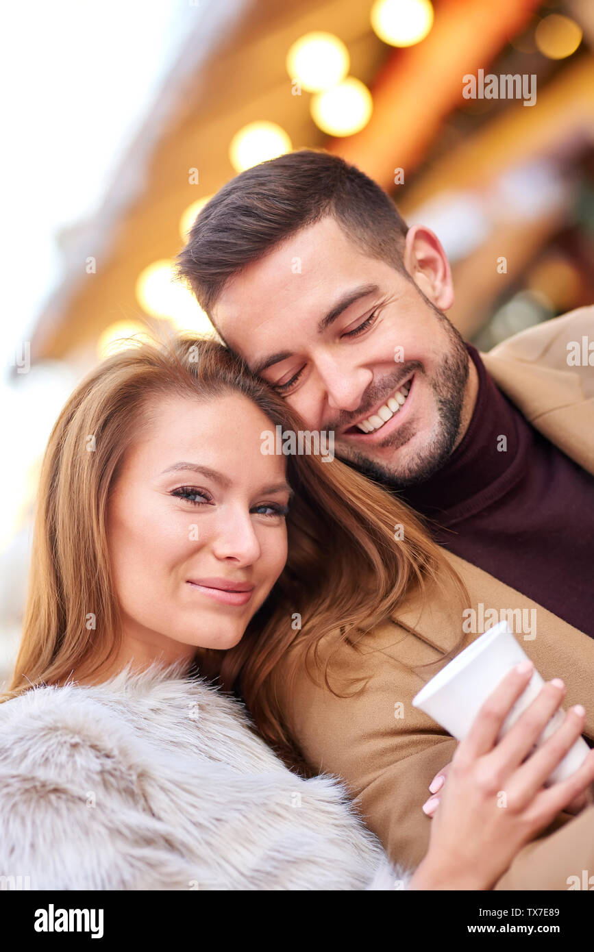 Portrait of a beautiful young couple drinking mulled wine in a ...