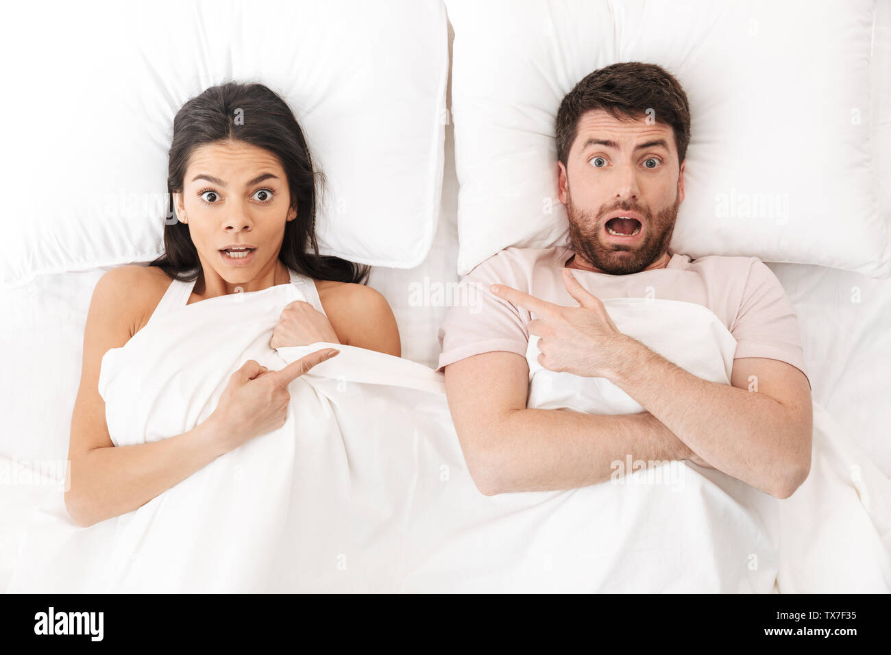 Image of a displeased shocked scared confused young loving couple in ...
