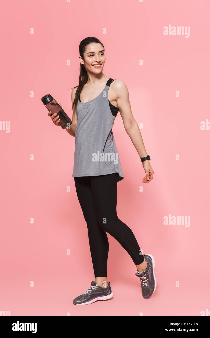 Image of amazing beautiful young pretty fitness woman holding bottle ...