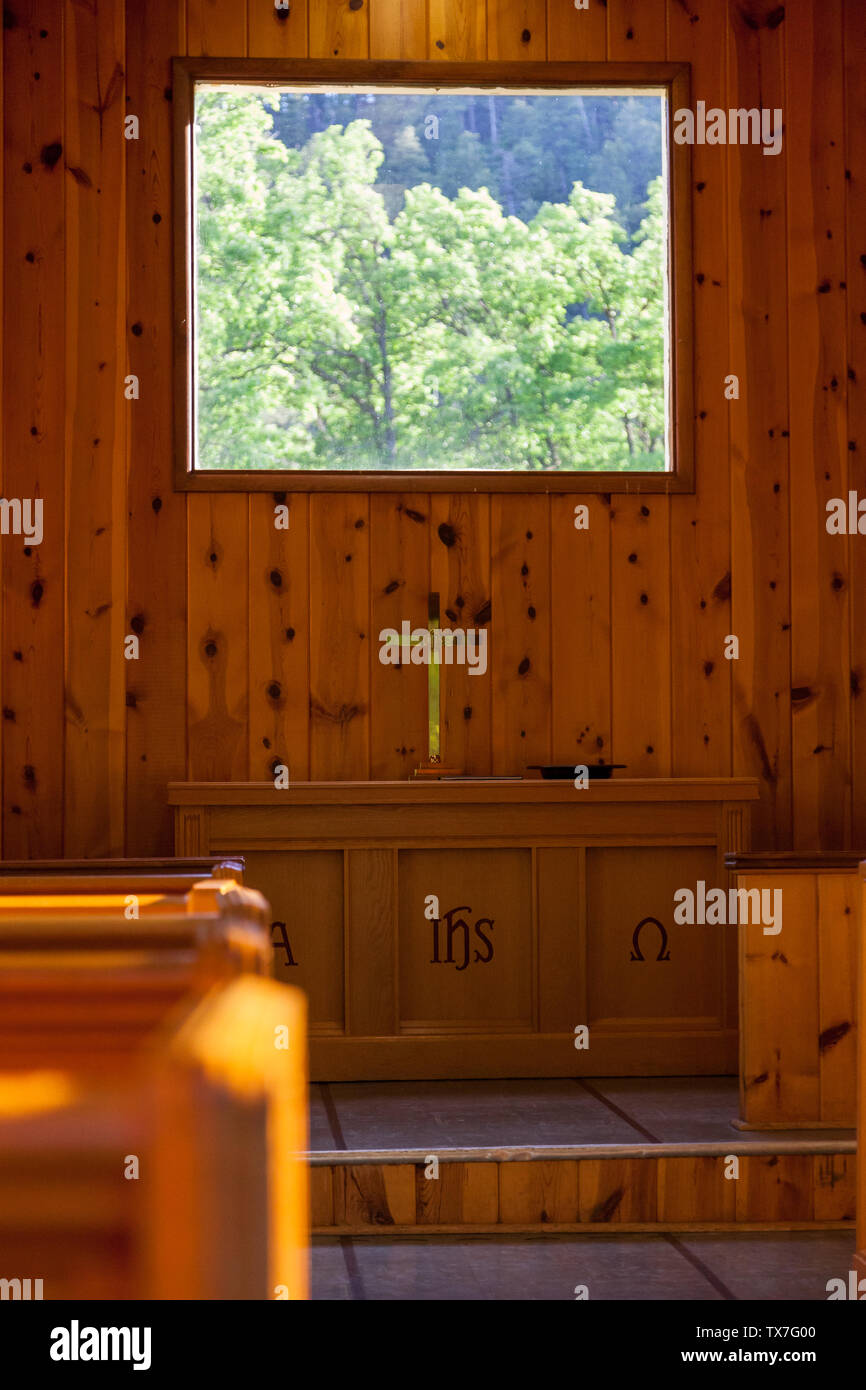 The interior of a small country chapel with a gold cross and soft ...