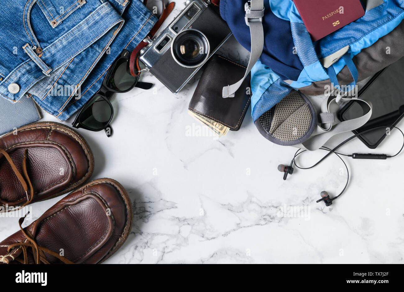 prepare backpack accessories and travel items on marble background with ...