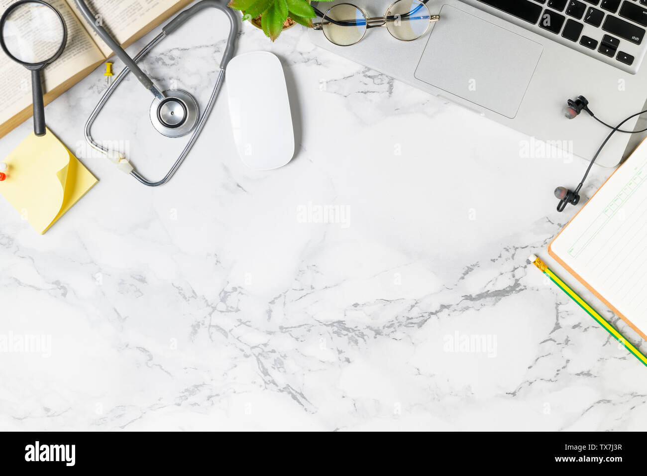 Top view of doctor desk marble table with stethoscope and notebook ...