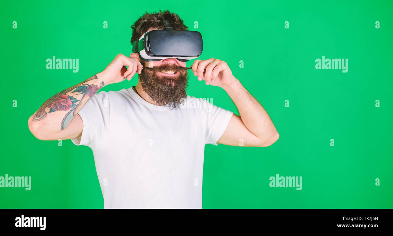 Hipster with cunning expression exploring VR with modern gadget. VR ...