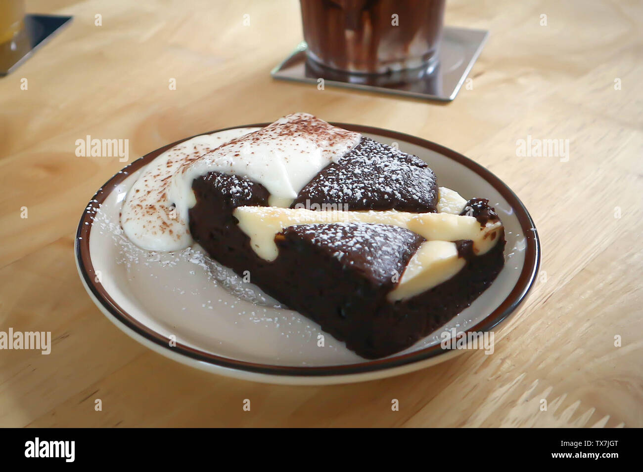 chocolate cake or brownie with cream topping Stock Photo - Alamy