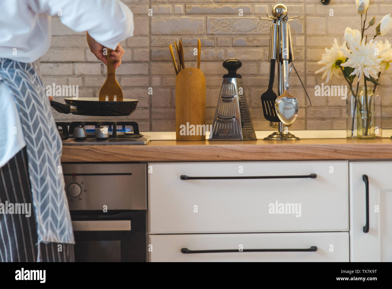 woman fry on pan kitchen view. copy space Stock Photo - Alamy