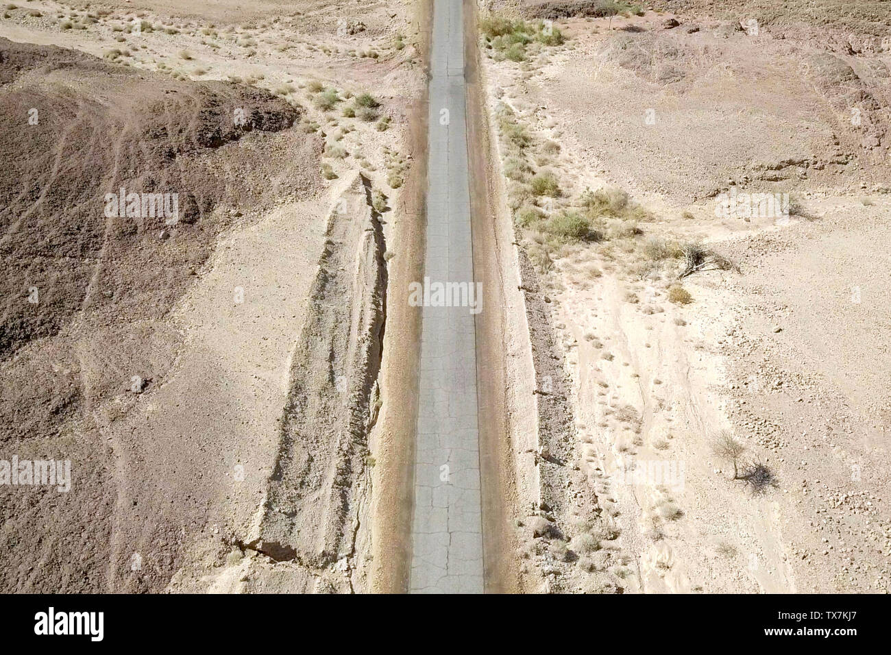 Old Desert road with cracked asphalt, Top down aerial image Stock Photo ...