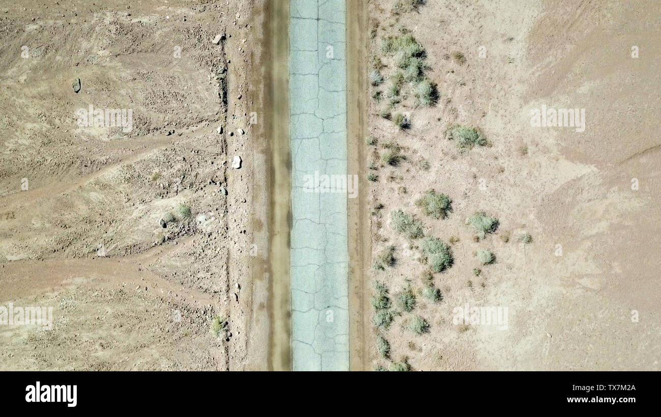 Old Desert road with cracked asphalt, Top down aerial image Stock Photo ...