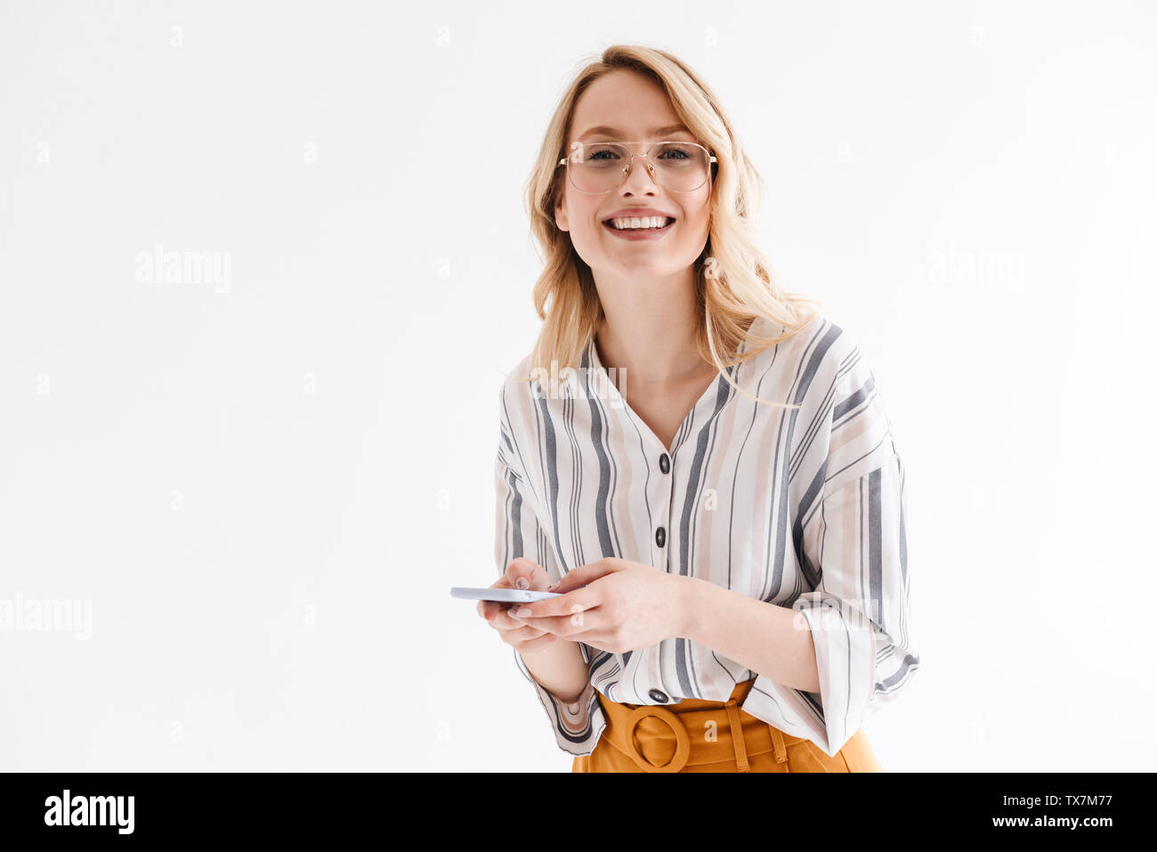 Photo of optimistic beautiful woman wearing glasses smiling at camera ...