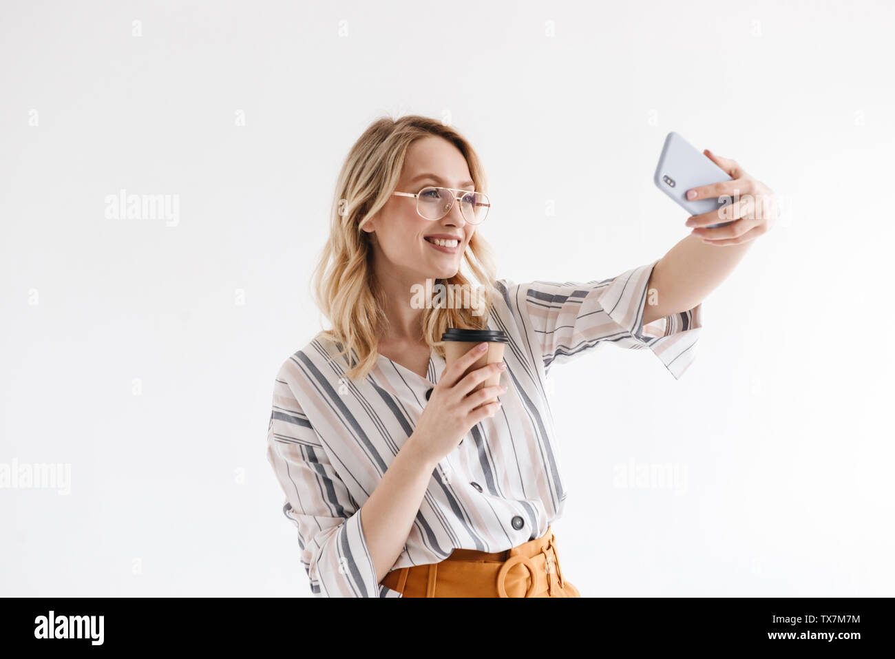 Photo of smiling young woman wearing glasses taking selfie photo and ...
