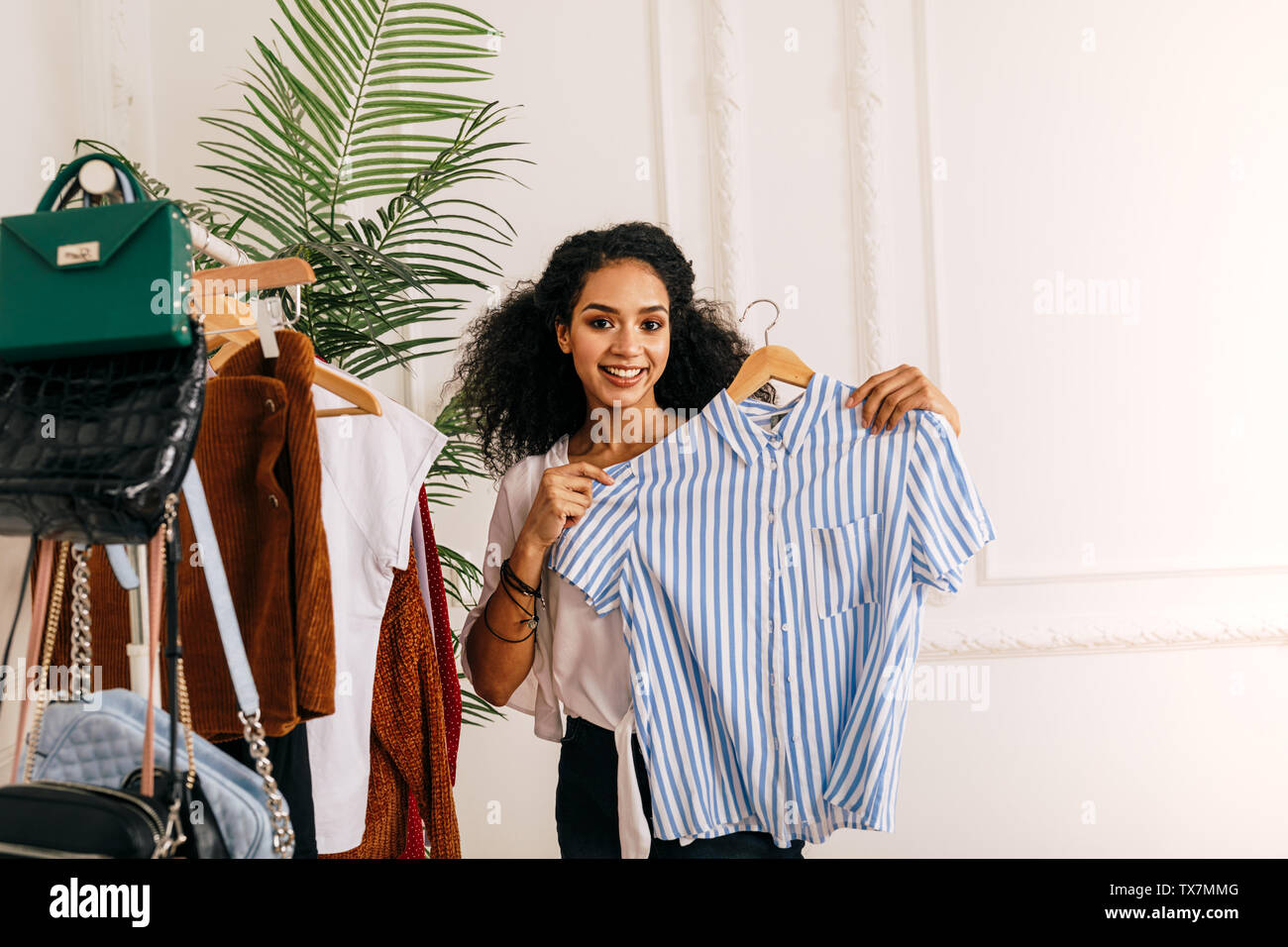 Woman holding hanger beautiful hi-res stock photography and images - Alamy