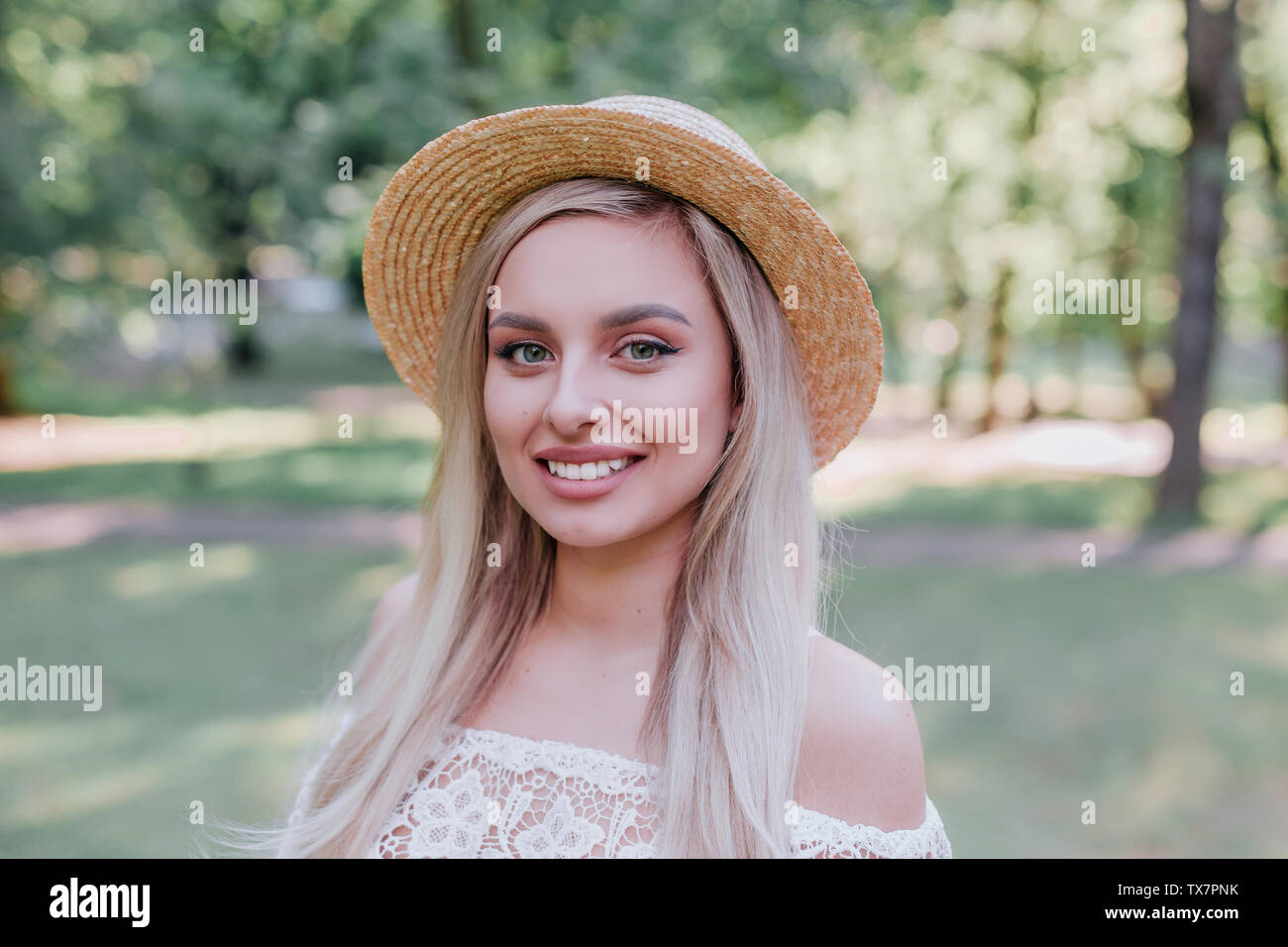 Close up portrait of a beautiful blond hair girl in vintage straw hat ...