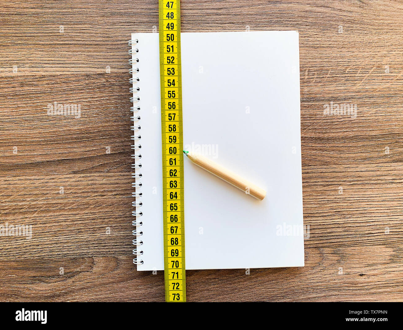 Diet concept. Measuring tape on wooden background with book diary ...